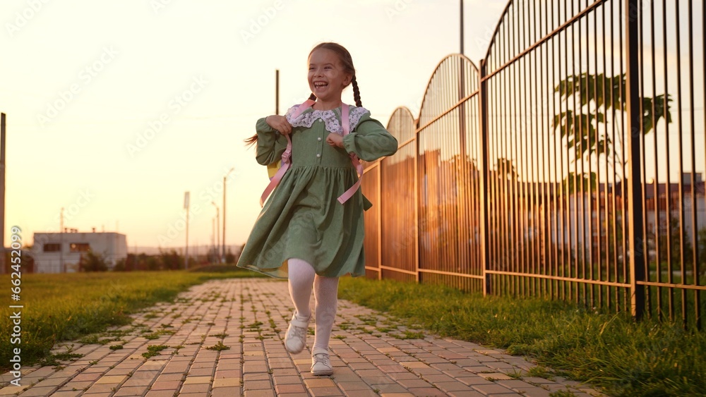Foto de happy child with school backpack runs along way school ...