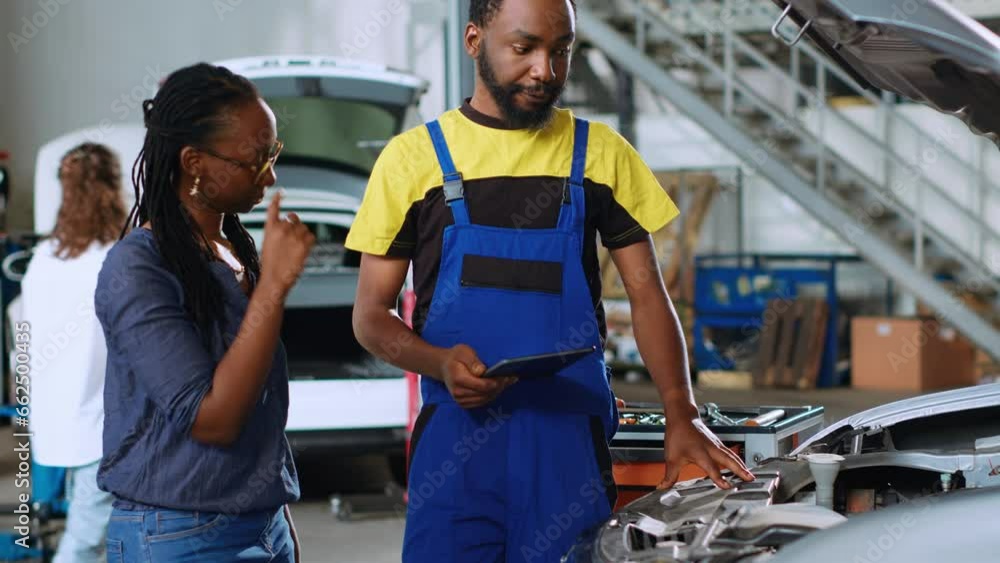Seasoned auto repair shop mechanic showing client defects found inside ...