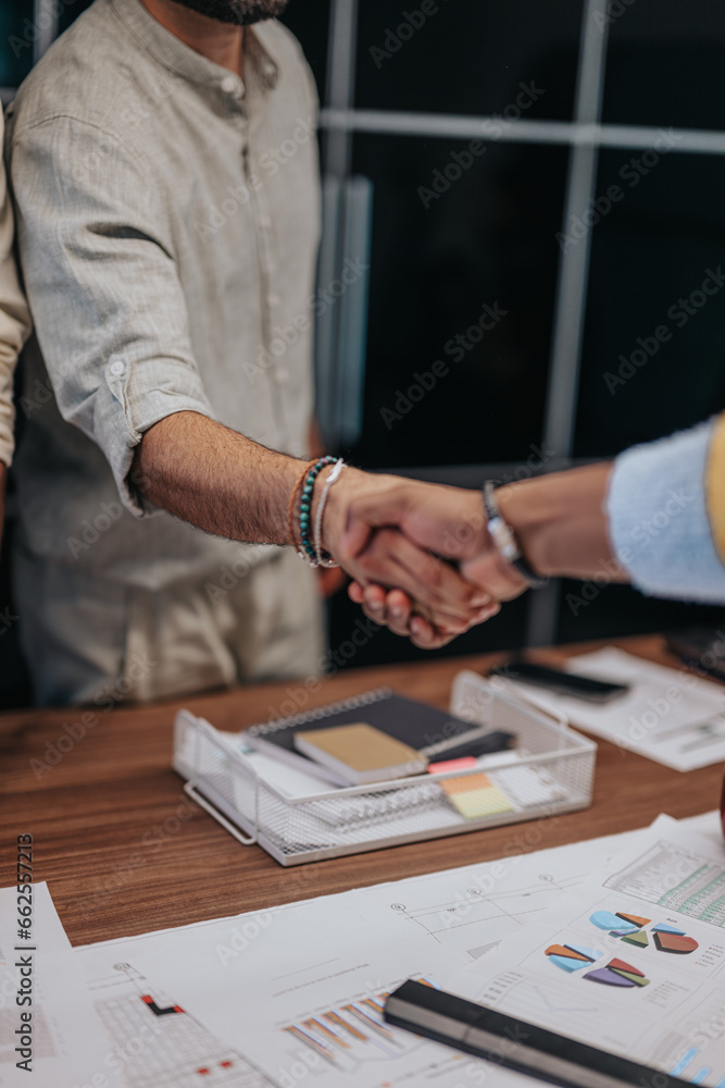 Multicultural colleagues bid farewell, embracing as one begins a new job. A touching moment of ...