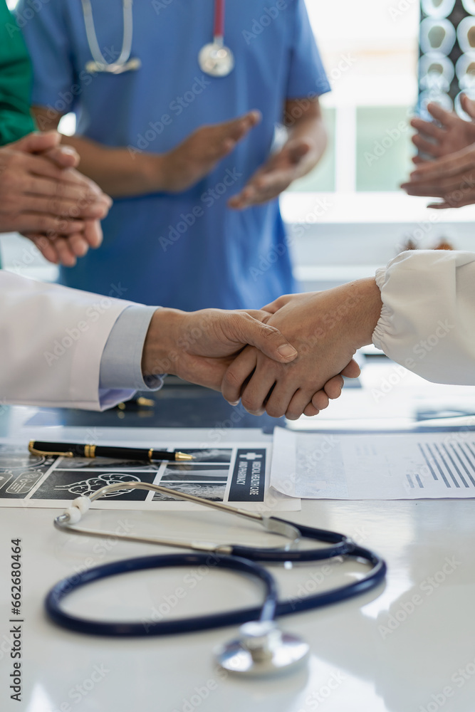 Medical team joins hands in medical meeting treating sick people and ...