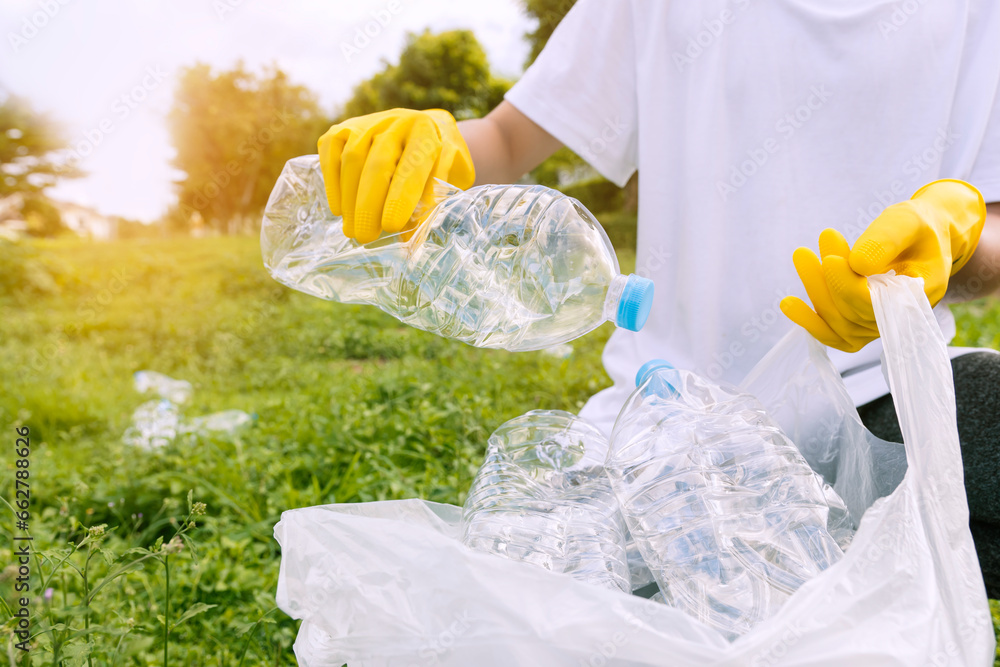 Volunteer teenage boys are holding garbage bags and Collecting plastic ...
