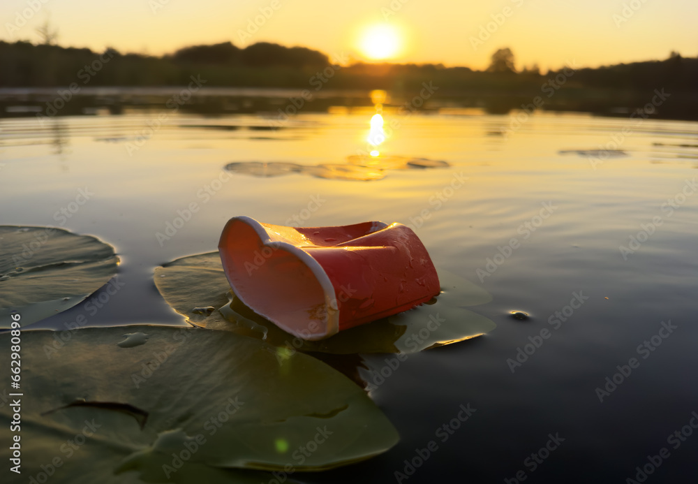 Water pollution. Coffee paper cup Garbage. Marine pollution. Aquatic ...