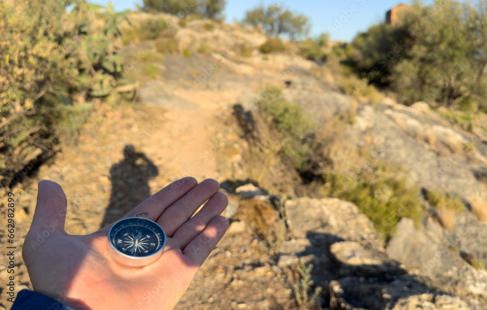 Compass in hand in mountains. Tourist compass for orientation on ...