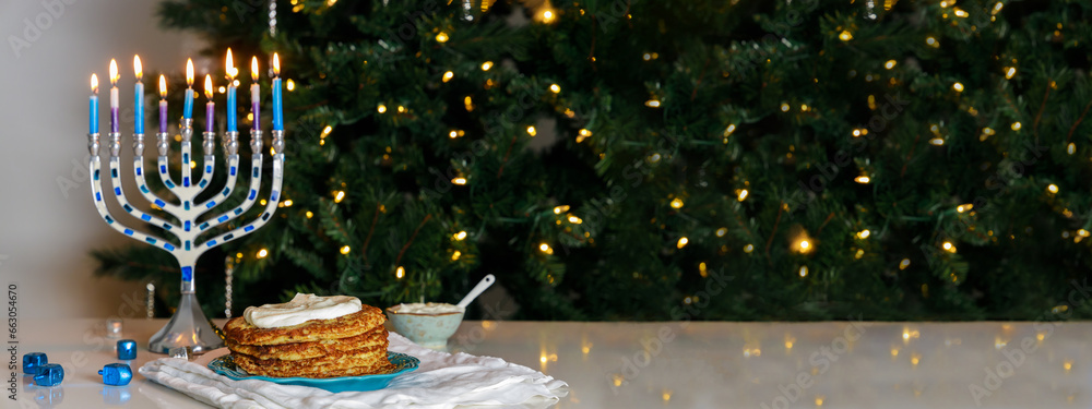Jewish holiday dinner with a menorah and crispy potato latkes. Stock ...