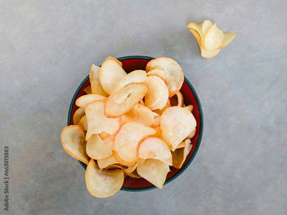 Cassava chips served in a bowl. Traditional snack made from thinly ...