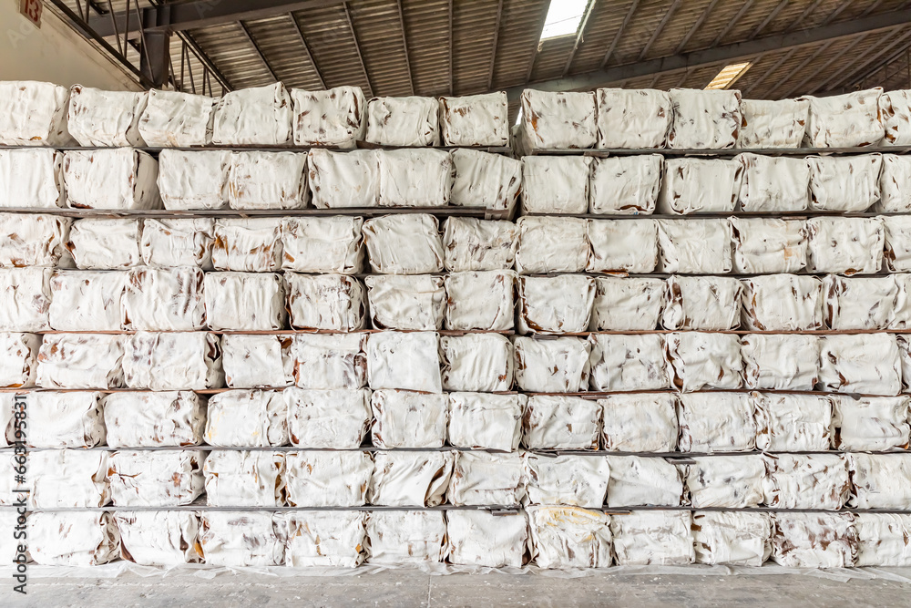 The natural Thai standard rubber bales sheet products staked and stored ...