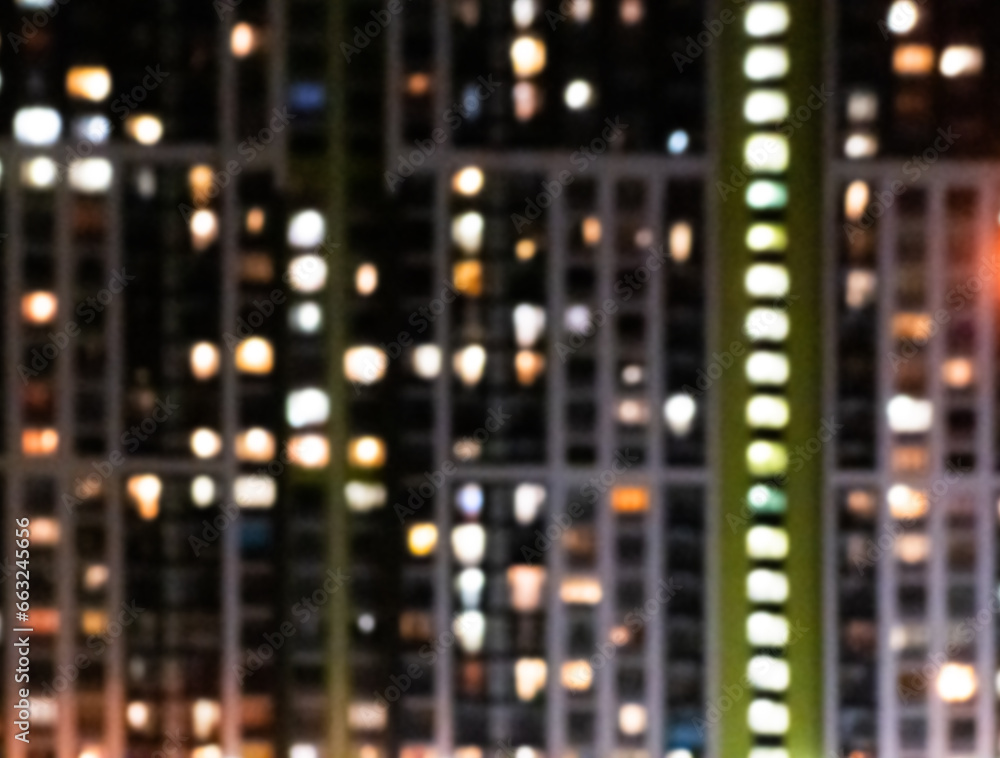 Blurred office building with illuminated facade exterior at night ...