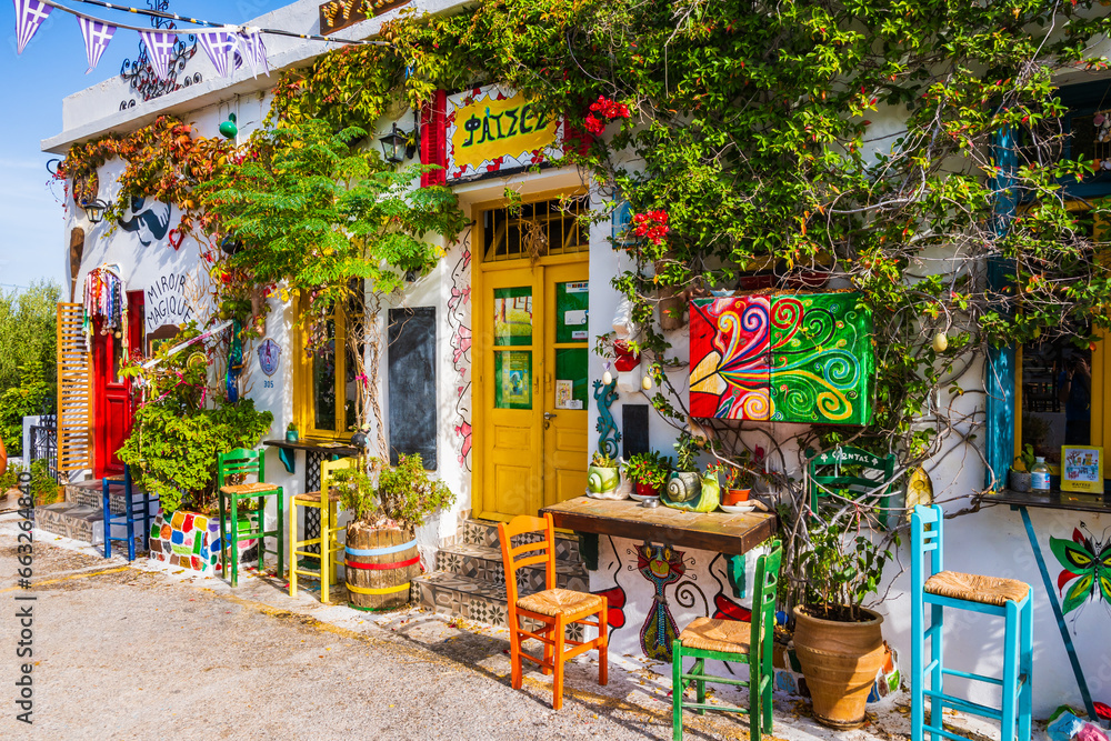 PLAKA VILLAGE, MILOS ISLAND - SEP 24, 2023: Colorful tavern chairs with ...