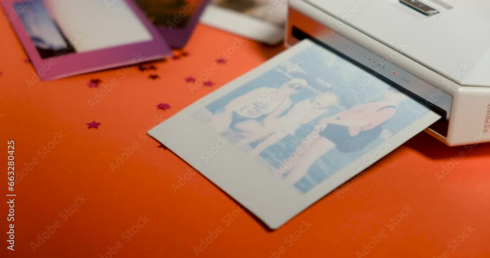 Print of colorful photos on small printer. Fast Developing of photo ...