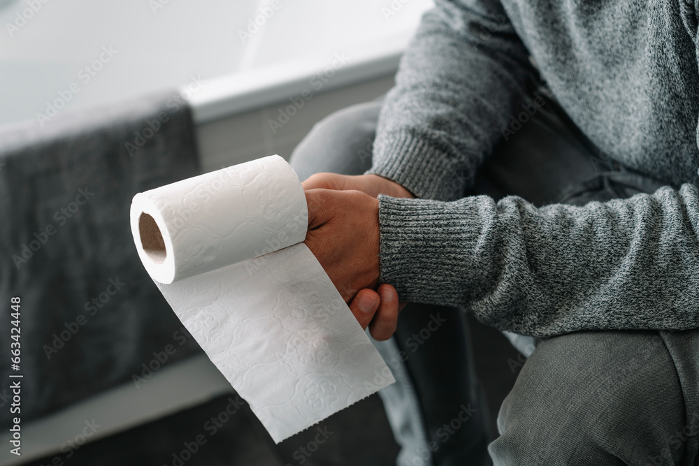 man with a paper roll in his hand sitting in the toilet Stock Photo ...