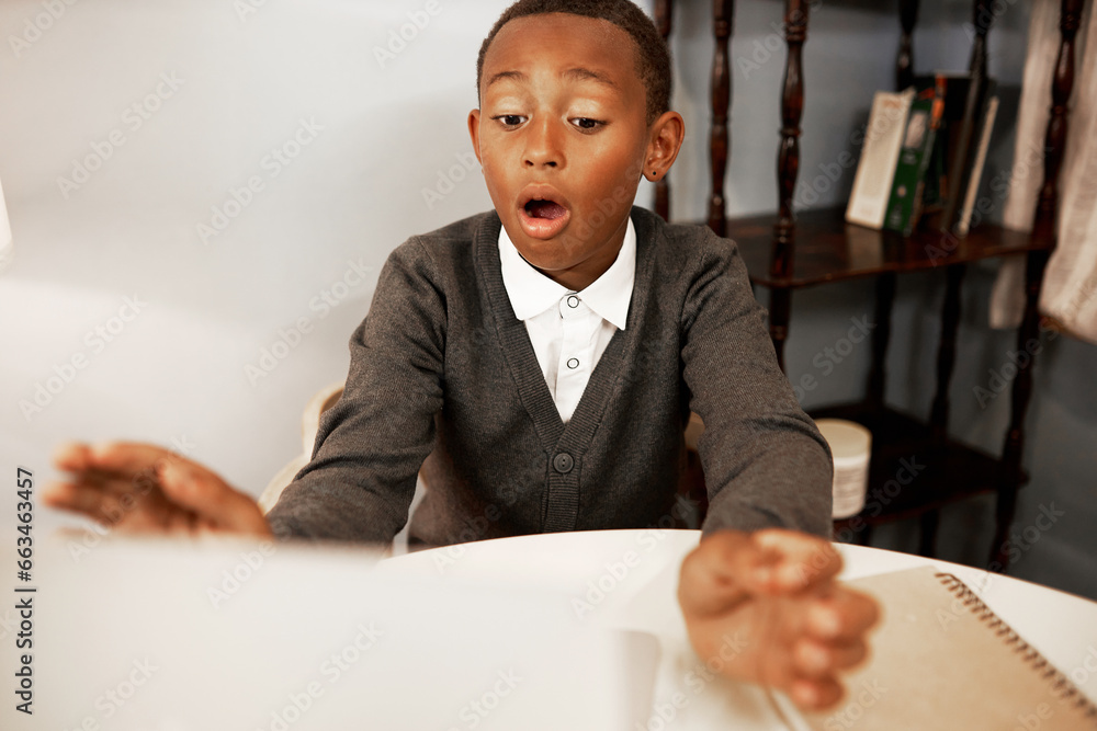 Upset distraught black schoolboy sitting in front of laptop at home ...