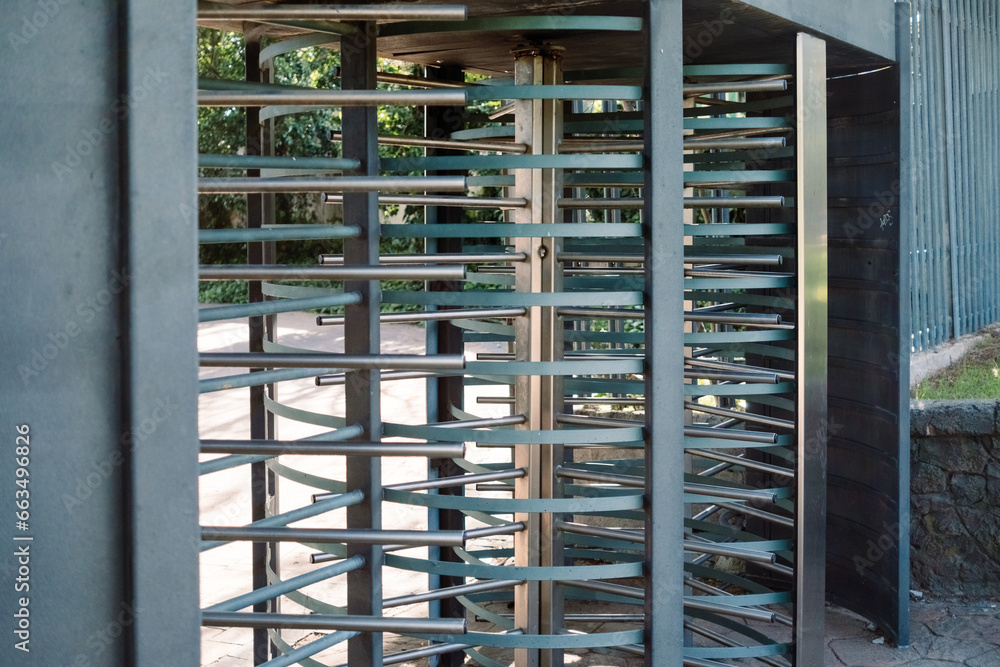 Controlled access revolving door with metal security bars. Stock Photo ...
