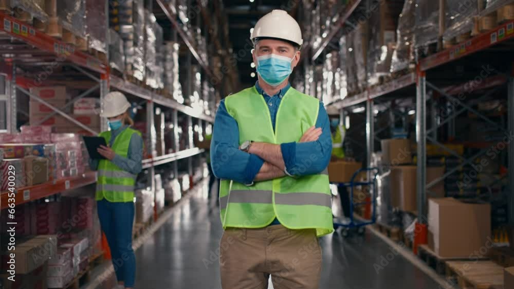 Vidéo Stock Male worker standing at storage of logistic enterprise. Man ...