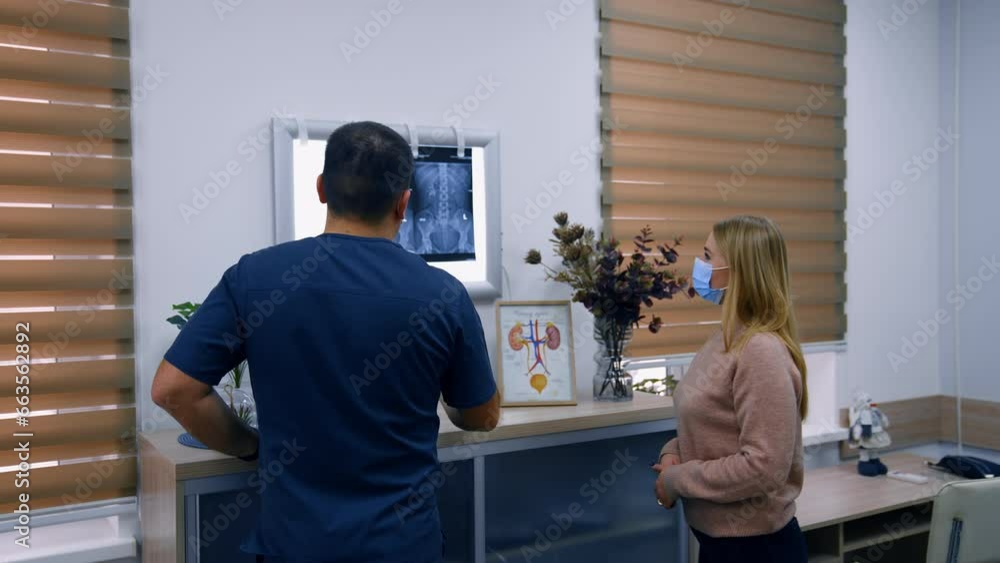 Patient and doctor standing in the hospital cabinet. Medic explaining ...