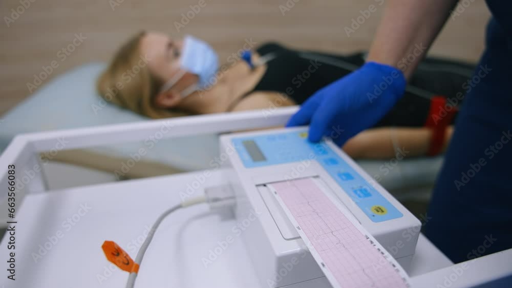 Paper with heart test result appears from electrocardiograph. Close up ...