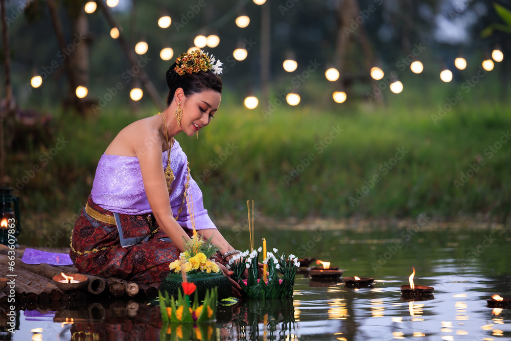 Loi Krathong Festival, Thai woman holding a krathong sitting on a raft ...