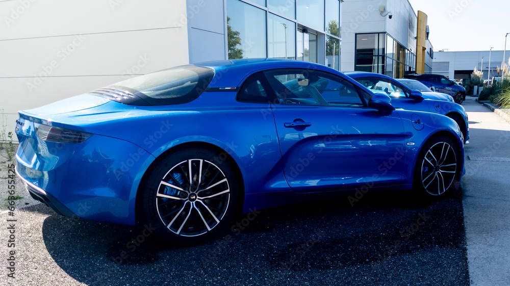 Alpine A110 logo on blue french sport car dealership store building ...