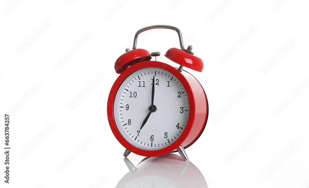 Red alarm clock isolated on white background shows seven o clock in the ...