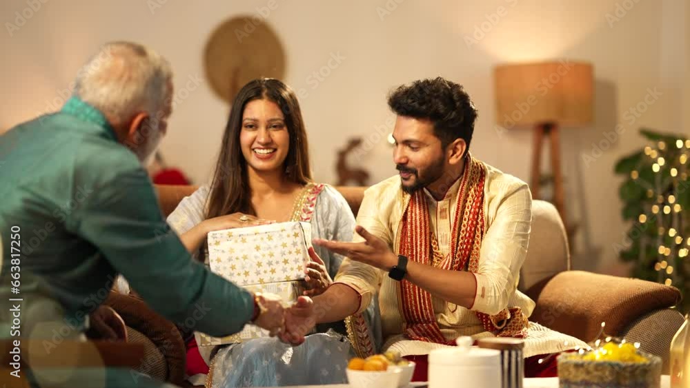 Indian couple taking gift from relatives during diwali.they are all ...