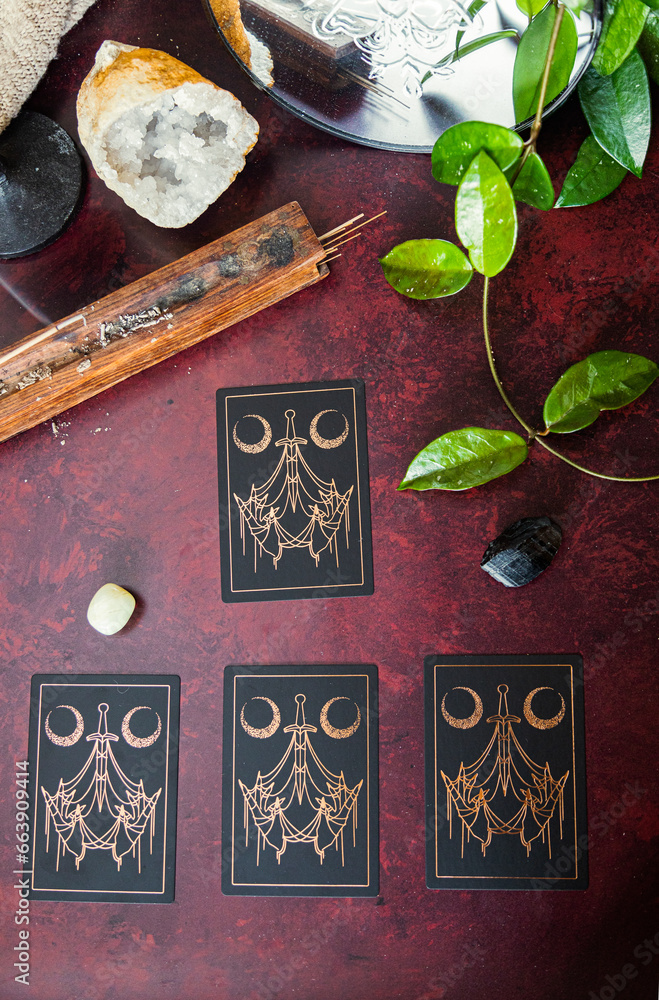 Oracle reading cards on red mat table with candles gemstones plants and ...