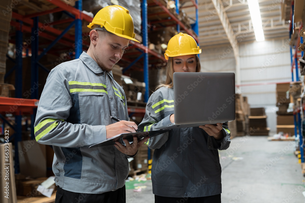 Male and female warehouse worker working and discussing in warehouse ...