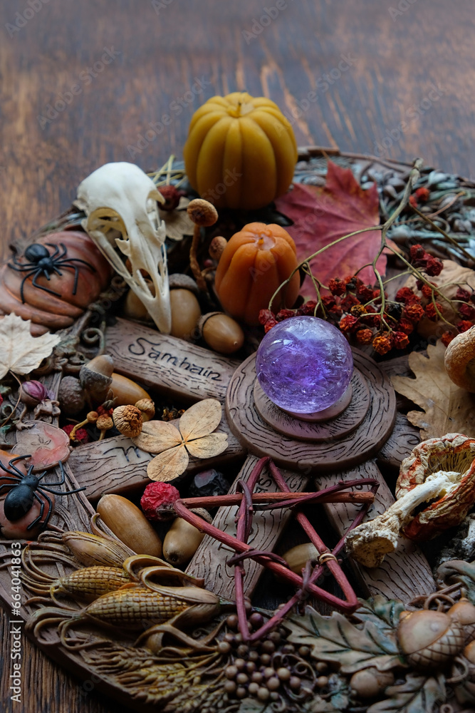 wiccan altar with wheel of the year close up on dark wooden background ...