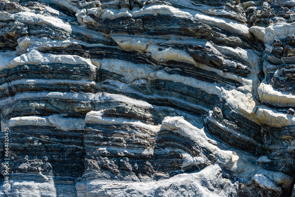 Compressed rock layers formation in various colors and thicknesses, on ...
