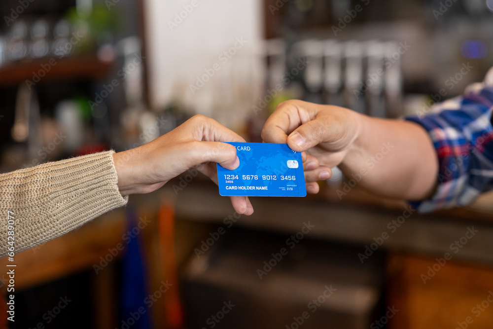 Customers standing near the bar counter paid using their credit cards ...