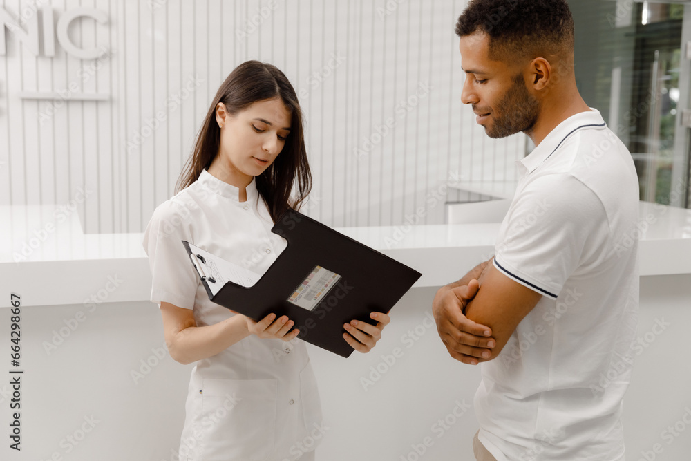 In front of the camera man at medical clinic have a conversation with ...