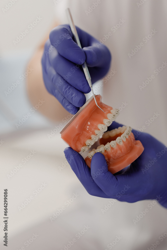 The dentist shows how to brush your teeth with a toothbrush on the ...