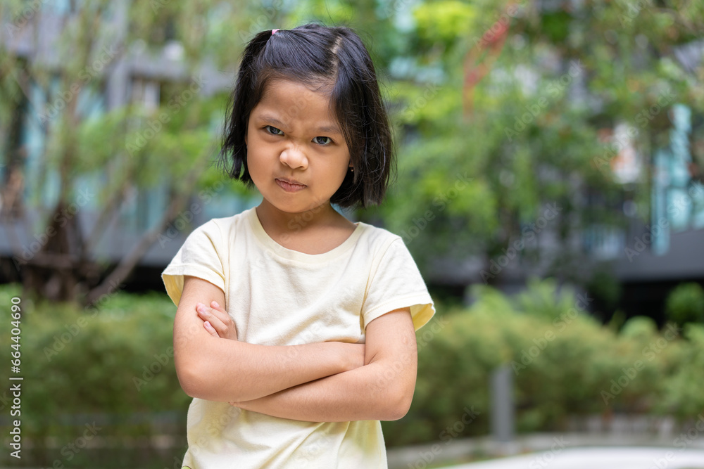 Portrait of an Asian angry and sad little girl. The emotion of a child ...