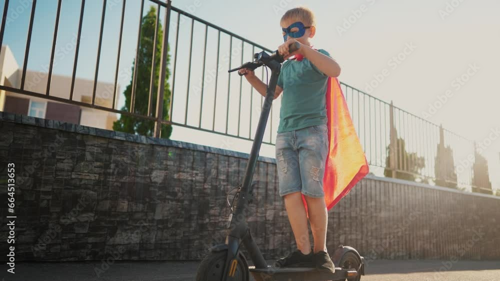 boy superhero on electric scooter. happy family kid dream concept. a ...