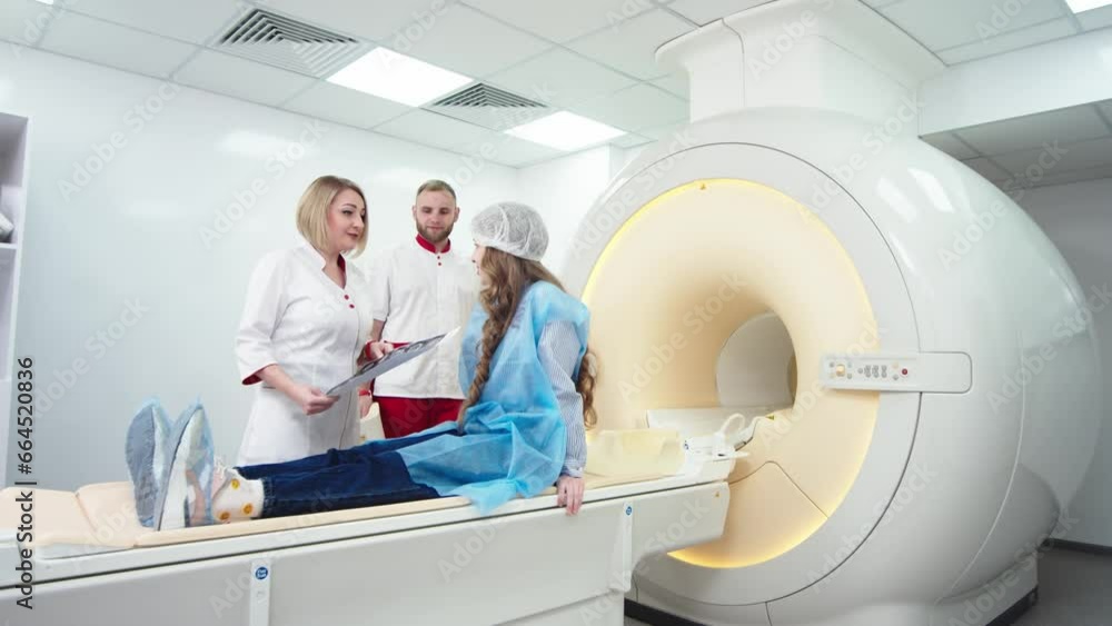 In a modern clinic, a female radiologist explains the good results of a ...