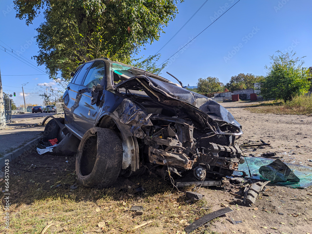 Car accident on a city highway. A wrecked car beyond repair thrown on ...