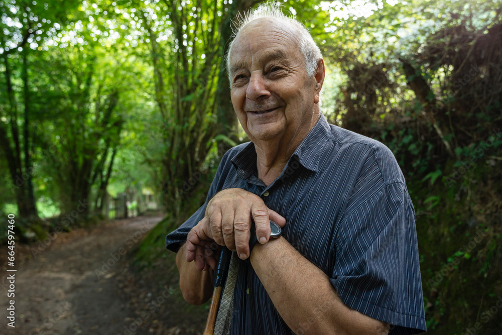 old man enjoying the walk in the forest, Paleolithic Park of the Cueva ...