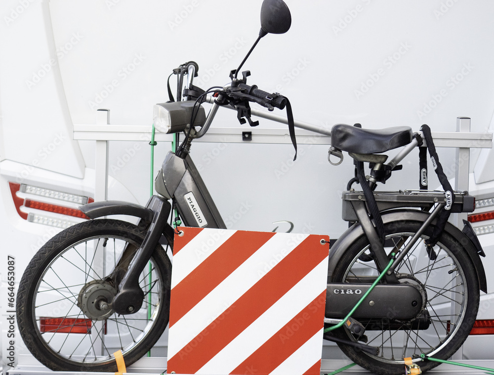 Vintage Ciao Piaggio moped carried on the rack of a camper van.Stresa ...