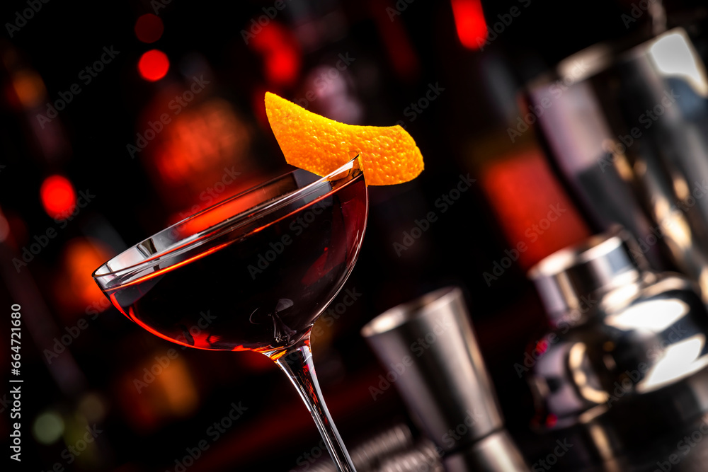 Adonis cocktail drink with sherry and red vermouth, black bar counter ...