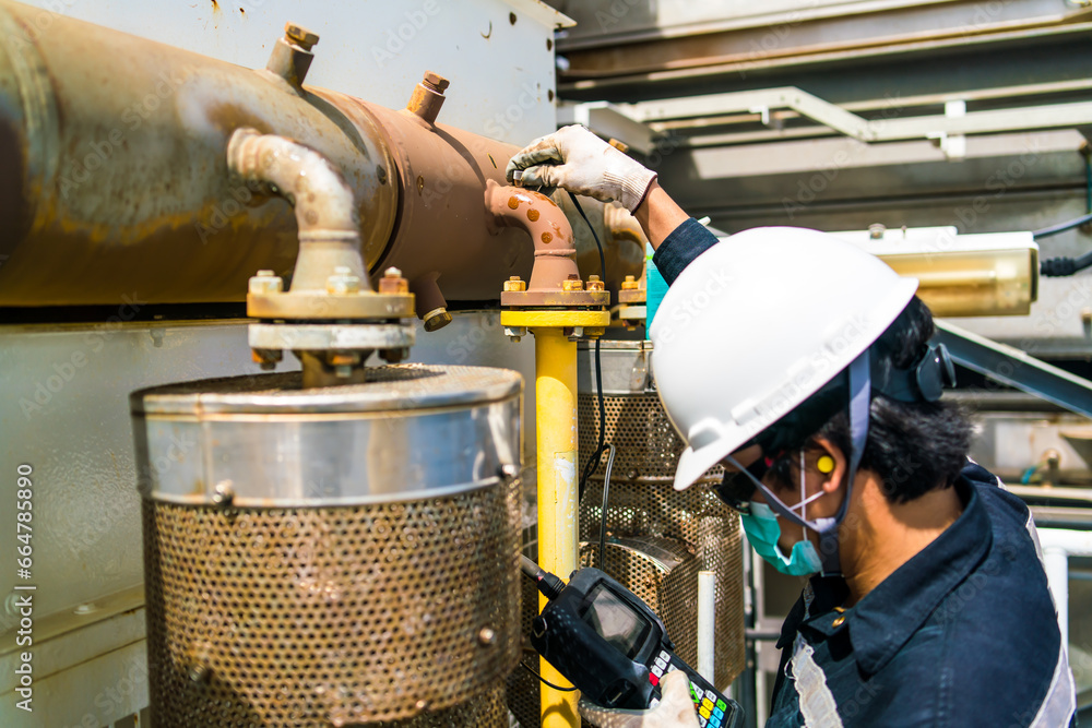 Non-destructive testing technicians are checking the thickness of elbow ...