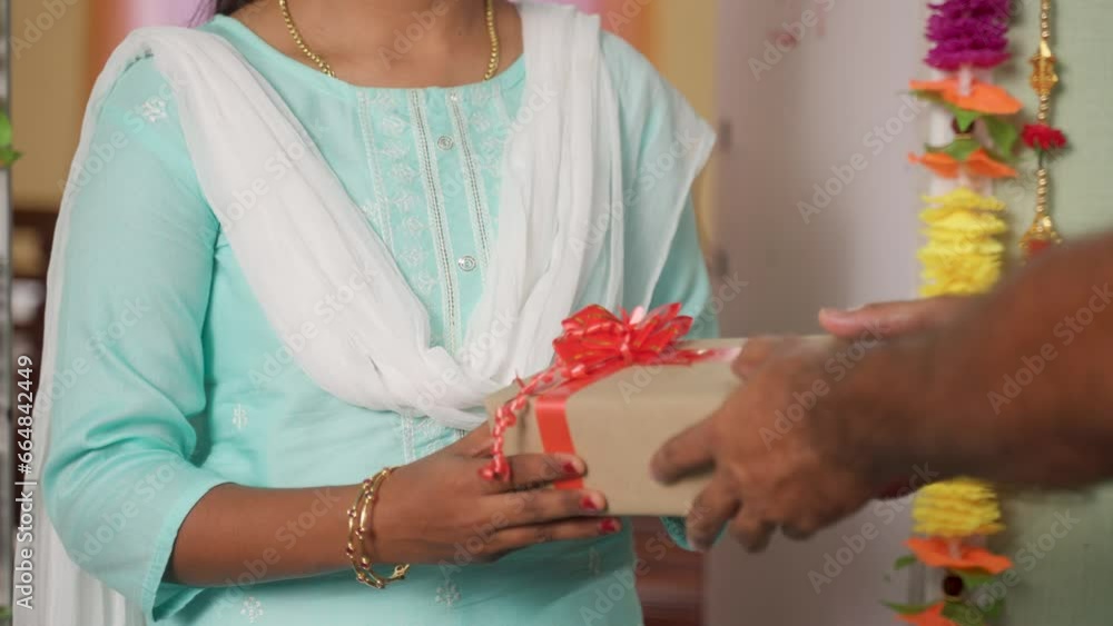 close up shot of indian girl hands receiving gift box from delivery ...
