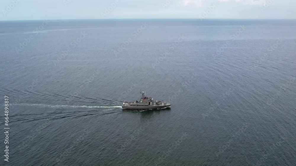 Naval ship is sailing at sea, aerial view. A gray navy ship operating ...