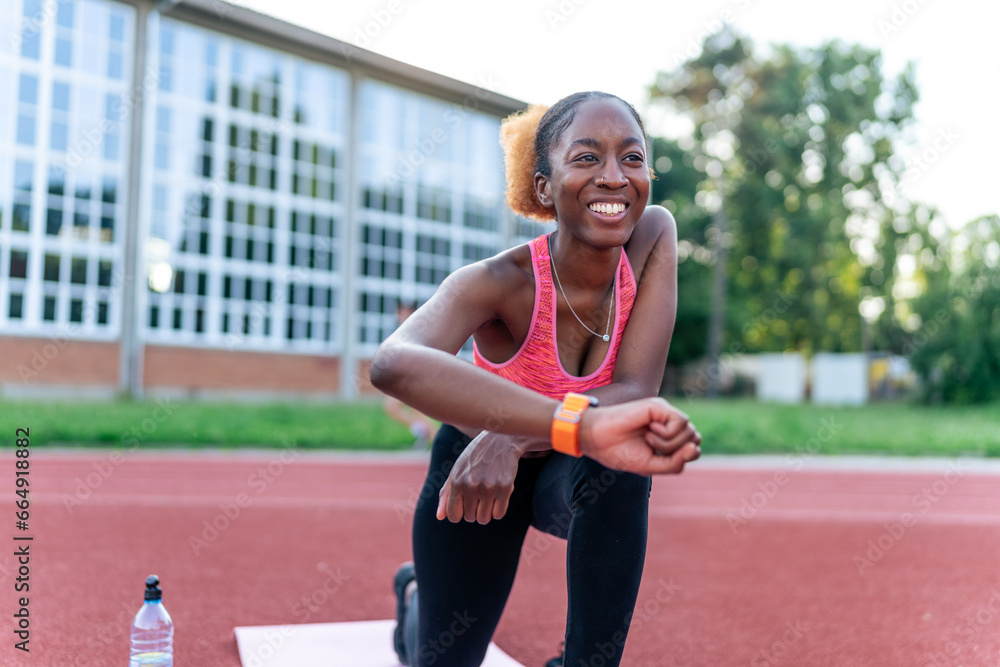 Engaged in her workout, the black woman excels on the exercise mat ...
