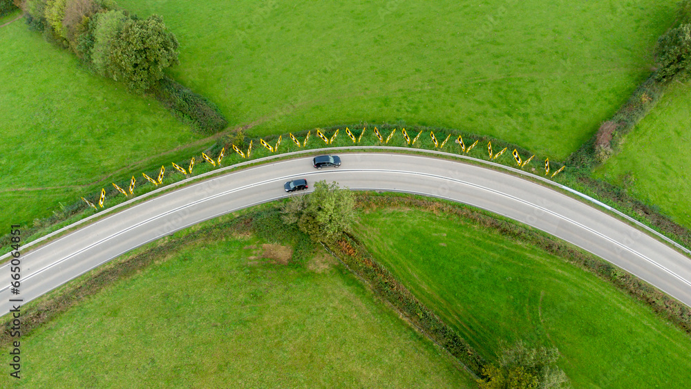 Sharp bend in a road with Chevron warning signs. Aerial view from above ...