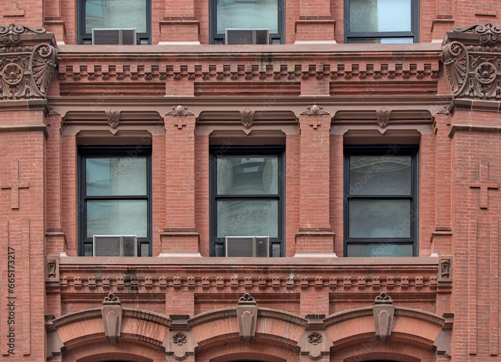 three windows with cornice detail in old historic commercial and ...