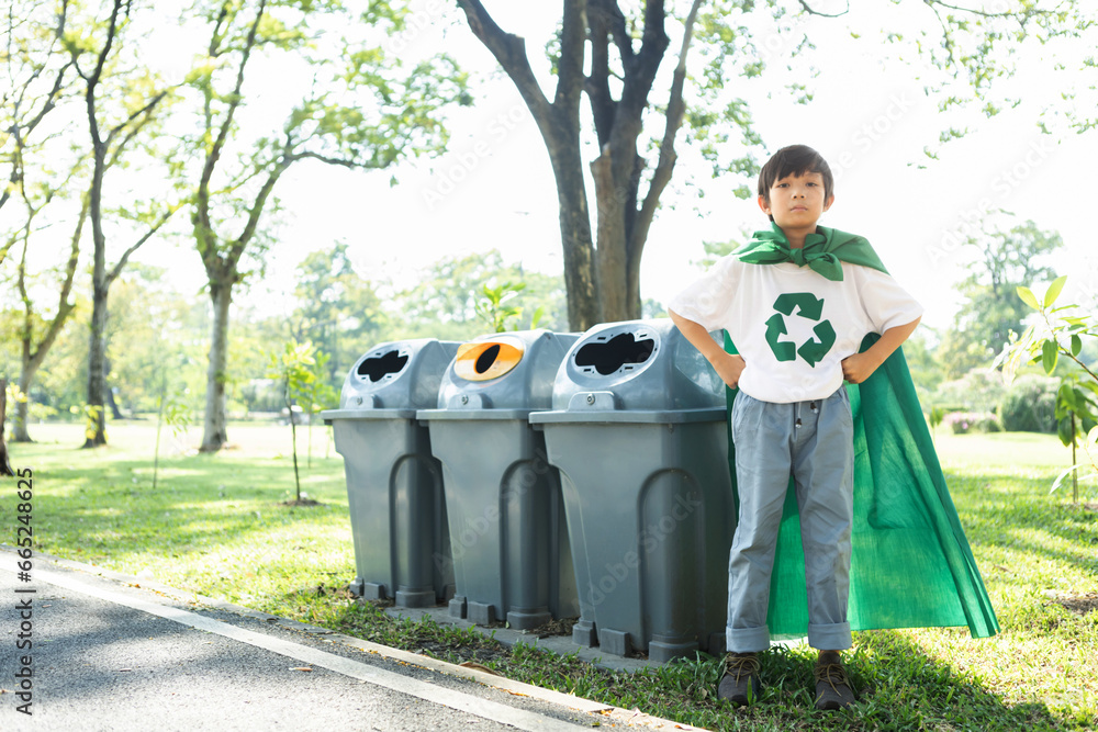 Cheerful young superhero boy with cape and recycle symbol promoting ...