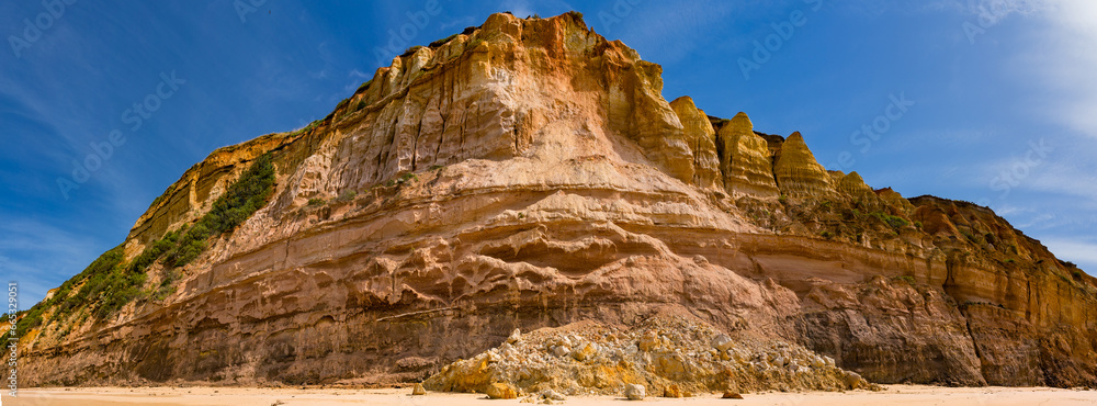 Rocks and rubble at the base of a coastal cliff face after a landslide ...