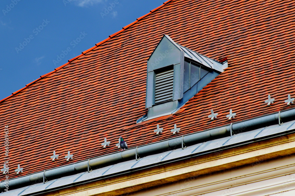 Sloped red clay tile roof . round ridge tiles. gray Zink plated roof ...