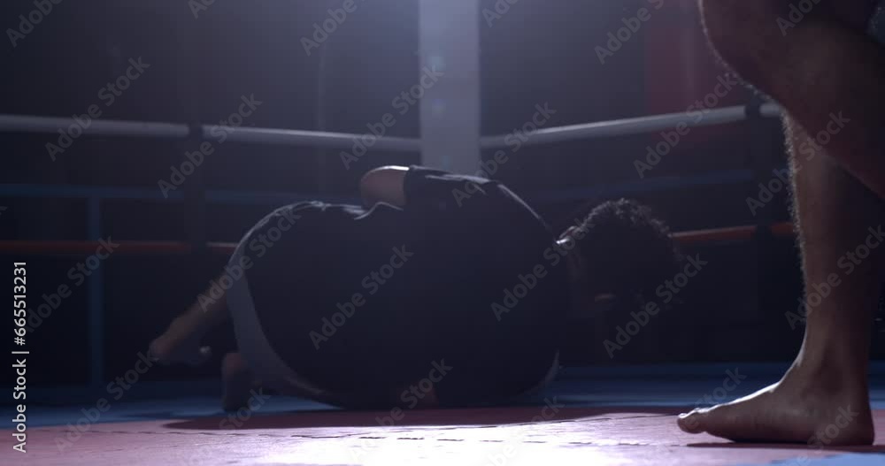 Boxing fighter on floor gets up after falling to the ground. Boxer ...