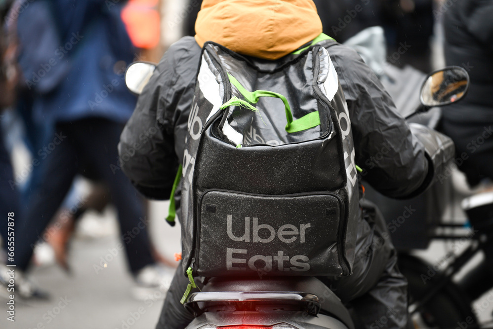 A deliver for Uber Eats or UberEats on his bike or motorcycle ...