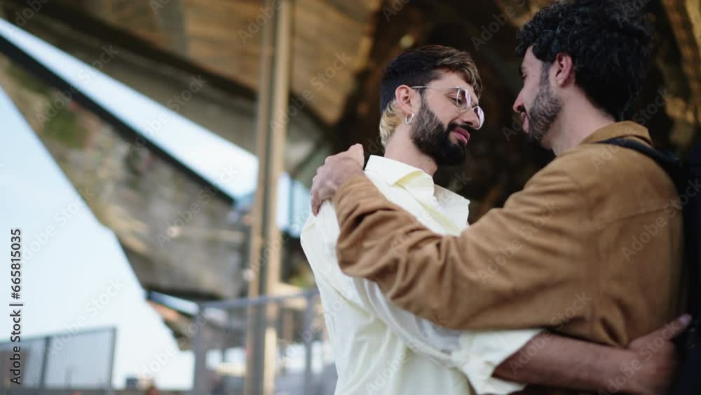 Two men in love, sharing close and joyful embrace, their faces lit with ...