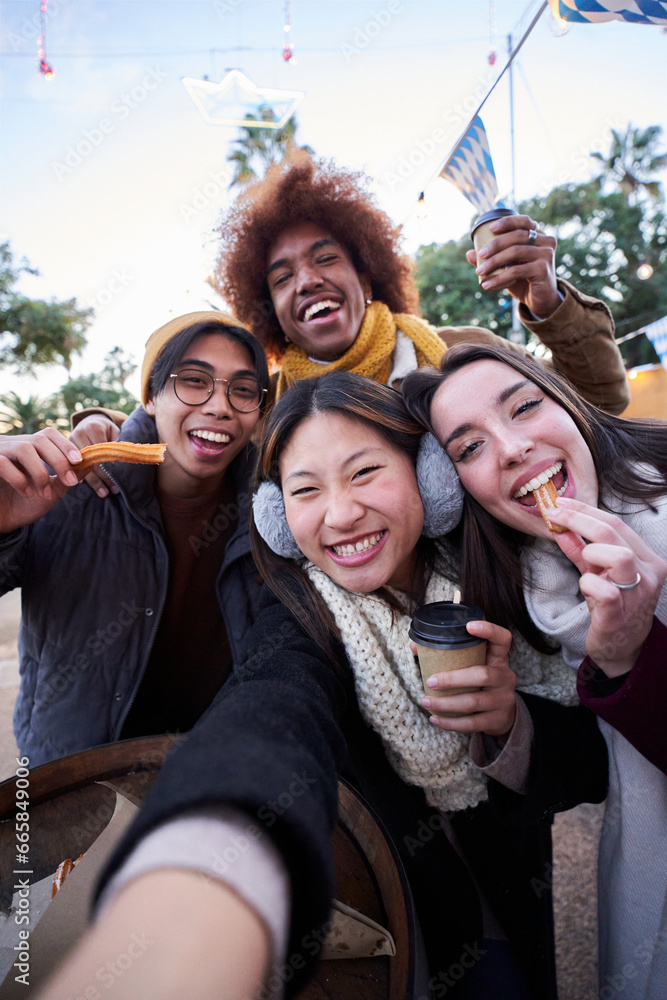 Vertical selfie phone looking camera of cheerful friends eating ...